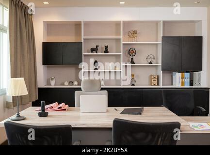 Comfortable office chair near wooden table with laptop computer Stock ...