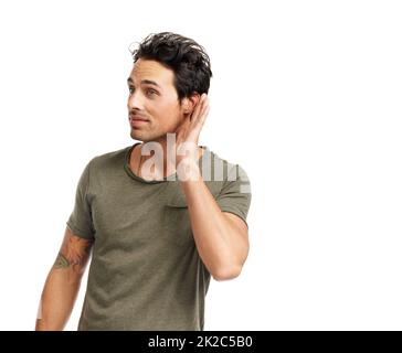 I cant hear you. A handsome young man cupping his hand behind his ear ...