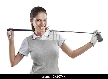 Confident golf player with club behind back smiling on camera at course ...