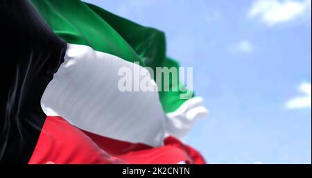 Detail of the national flag of Kuwait waving in the wind on a clear day ...