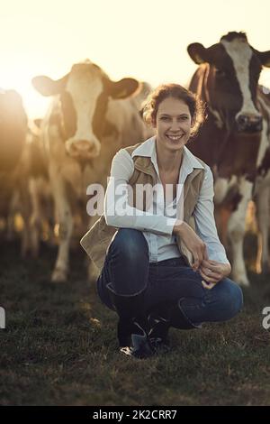 Female farmer posing in front of hay wagon. Portrait of woman farm ...