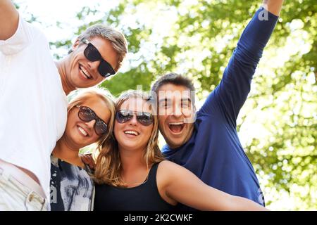 Outdoor festivities. Four friends partying and celebrating at a music ...