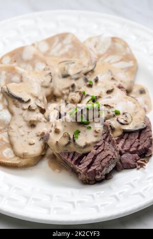 beef meat with mushroom sauce and dumplings Stock Photo - Alamy