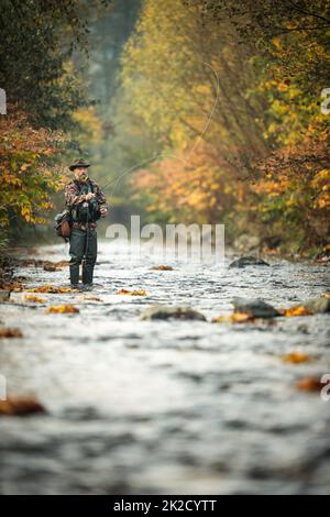 Fly fisherman fly fishing on a splendid mountain river Stock Photo - Alamy