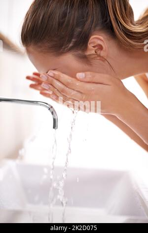 Beautiful skin begins with washing. Closeup shot of a young woman ...