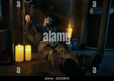 Chained zombie in basement of abandoned house Stock Photo - Alamy