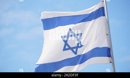 Israeli flag weaving in the wind against bright skies Stock Photo - Alamy