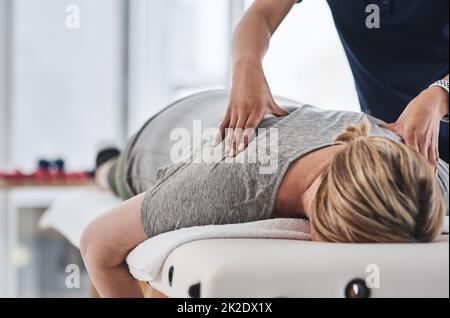Mature woman getting back massage Stock Photo - Alamy