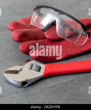 Protective gloves plastic goggles on wooden board Stock Photo - Alamy