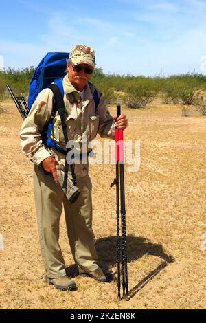 Senior hunter in sonora desert carrying rifle and pack Stock Photo - Alamy