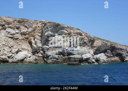 tall sharp cliff shooted from the water near at beach Stock Photo - Alamy