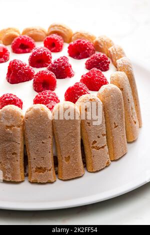 raspberry cream cake with Italian sponge cakes around Stock Photo - Alamy