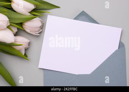 Blank invitation card mockup in craft envelope on gray concrete ...