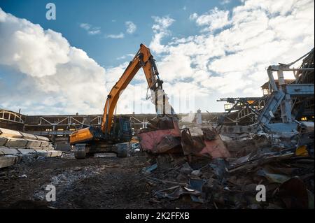 Excavator destroyer removes debris winter day Stock Photo - Alamy