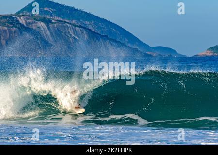 Surfer inside the tube in a wave Stock Photo - Alamy