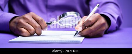 Auditor Using Magnifying Glass For Audit Stock Photo - Alamy