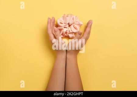 Female hand with silk scrunchy on white background Stock Photo - Alamy