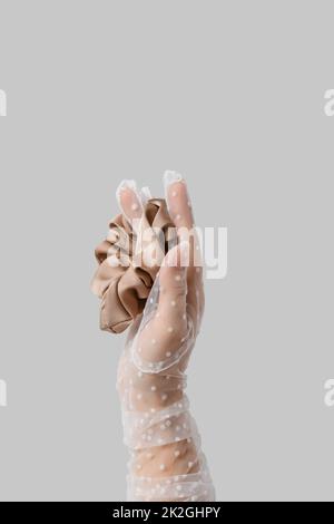 Female hand with silk scrunchy on white background Stock Photo - Alamy