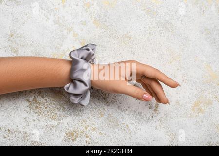Female hand with silk scrunchy on white background Stock Photo - Alamy
