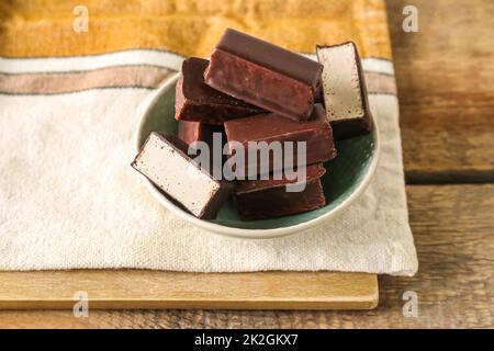 Bowl with tasty bird's milk candies on wooden table Stock Photo - Alamy