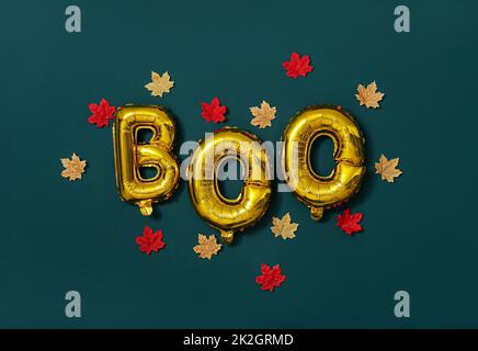 Word BOO made of balloons and fallen leaves on purple background ...