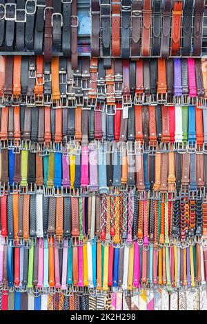 Colorful belts hanging for sale Stock Photo - Alamy