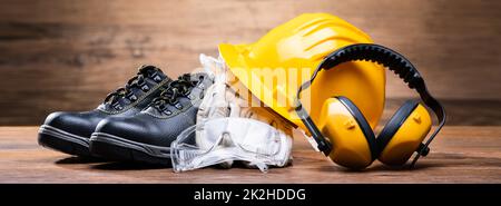 Protective leather gloves hard hat on corrugated metal background ...