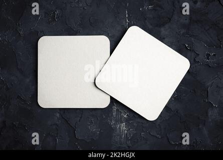 Two blank square beer coasters on black stone background Stock Photo ...