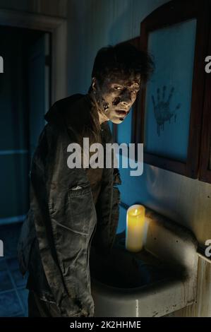 Sinister man Halloween crazy zombie with bloody wounded scars face ...