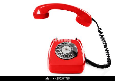 Vintage red corded telephone on light grey background Stock Photo - Alamy