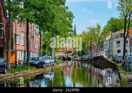 Cars on canal embankment in street of Delft. Delft, Netherlands Stock ...