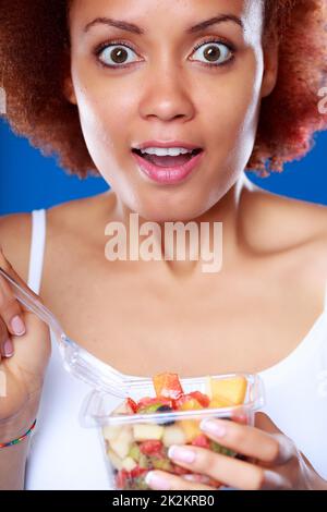 Young Black woman gawping at camera in amazement with staring eyes and ...