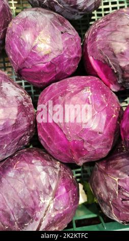 Purple cabbages stacked at a farmers' market. Cabbage on the market ...