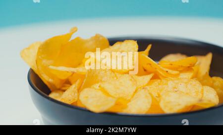 Ridged potato chips in bowl on wooden background Stock Photo - Alamy