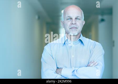 Inscrutable resolute businessman staring at the camera with a deadpan ...