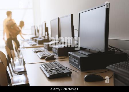 Row of computers and chairs in a classroom of a modern secondary school ...