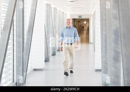 man walking down the hallway inside a new building Stock Photo - Alamy