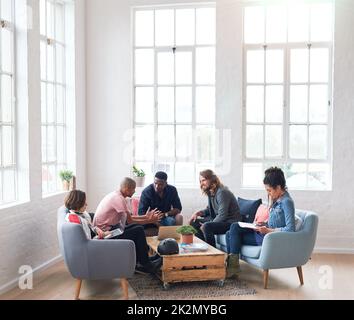 Creative millennial colleagues collaborating on a project in a modern ...