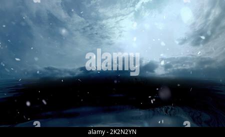 Snowing on Stormy Clouds Over Dark Ocean Stock Photo - Alamy