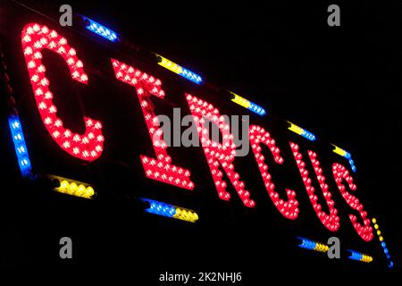 electric CIRCUS sign on a scaffolding in circus-style during the night ...