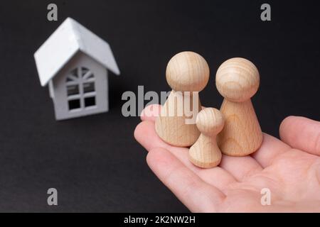 Wooden house model and model figurines. Healthy community together ...
