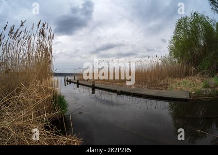 Small empty dock for boats on the lake Stock Photo - Alamy
