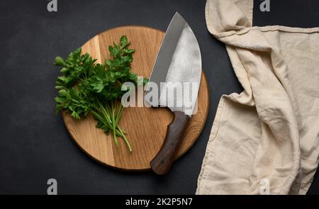 Parsley sprigs on wooden cutting board Stock Photo - Alamy