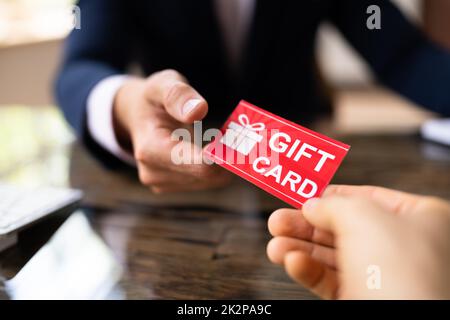 Holding Giving Gift Card Voucher Stock Photo - Alamy