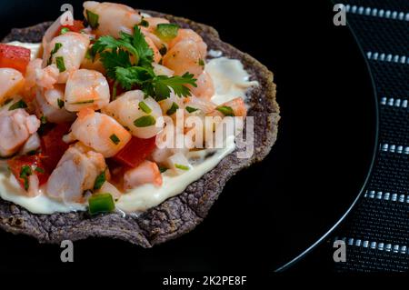 Red shrimp ceviche and blue corn tostadas Stock Photo - Alamy