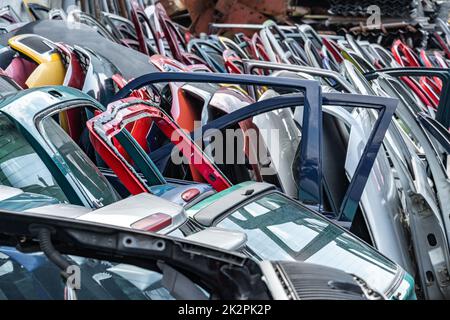 different colored car doors at a car junkyard Stock Photo - Alamy