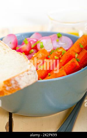 bowl of steamed root vegetable on a rustic white wood table Stock Photo ...