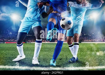 Football action scene with competing soccer players at the stadium ...