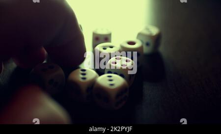 Finger tapping on table with dice on shallow depth of field Stock Photo ...