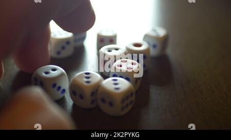 Finger tapping on table with dice on shallow depth of field Stock Photo ...